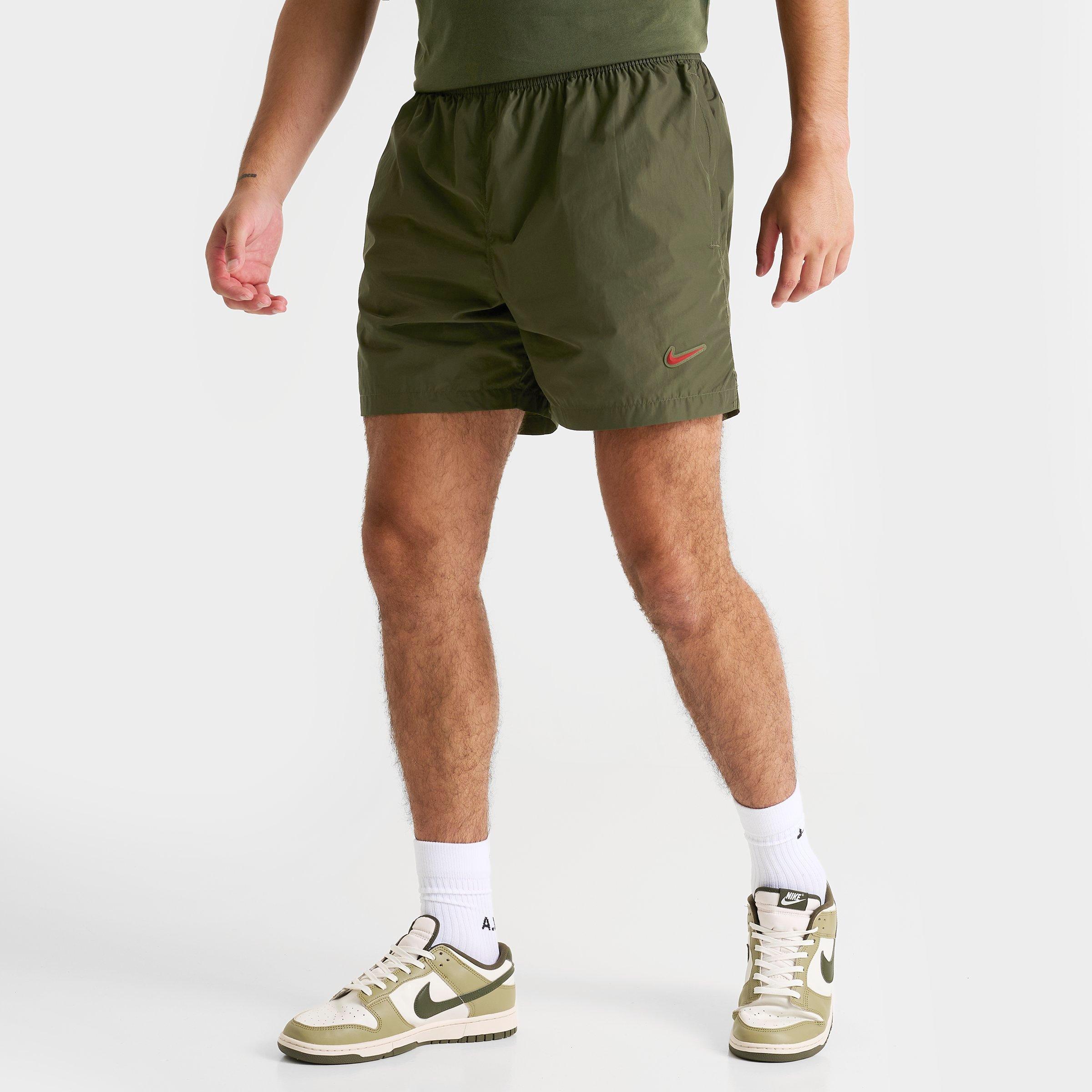 Click here for Nike Mens NOCTA Cardinal Nylon Shorts in Cargo Kha... prices