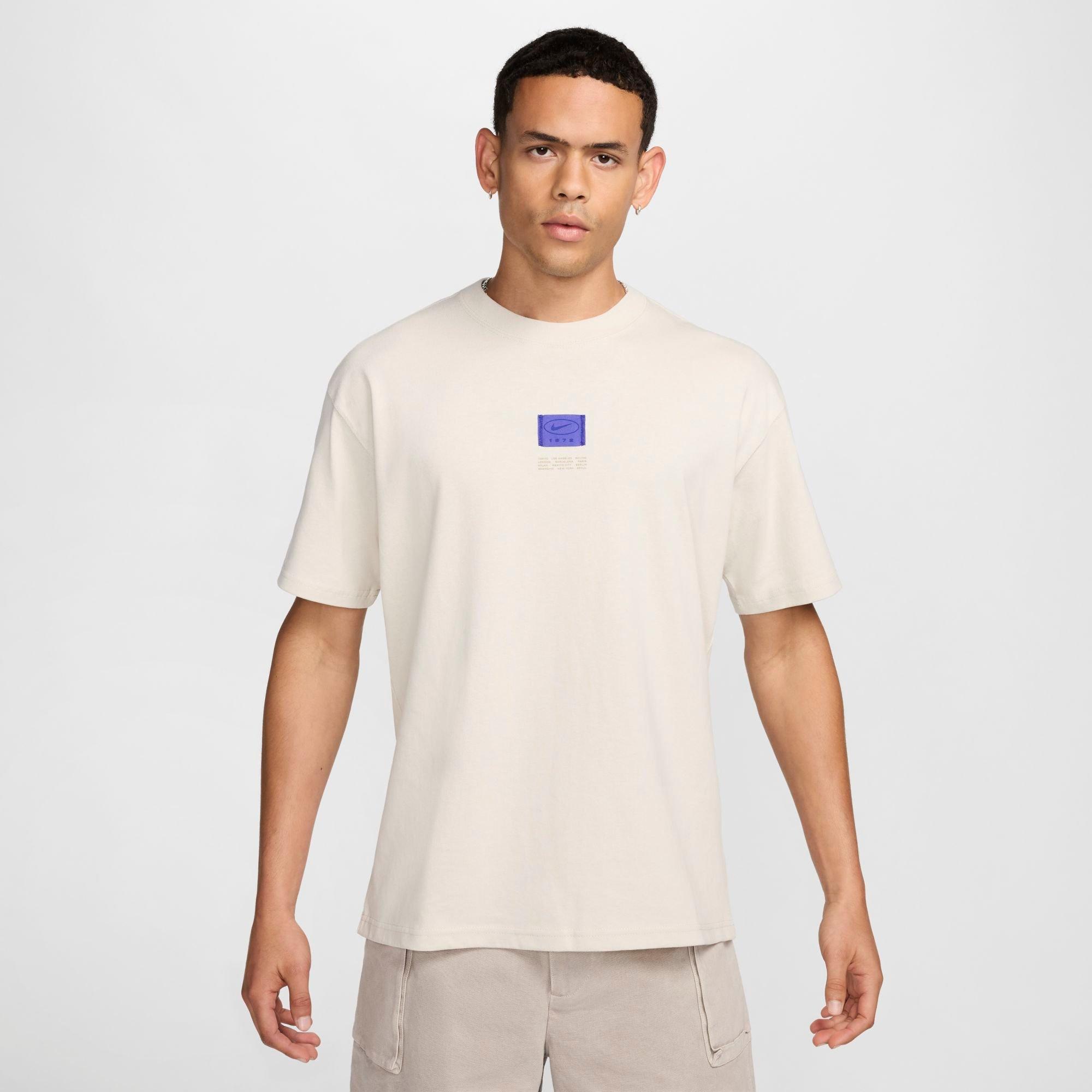 Click here for Nike Mens Sportswear Woven Label T-Shirt in Light... prices