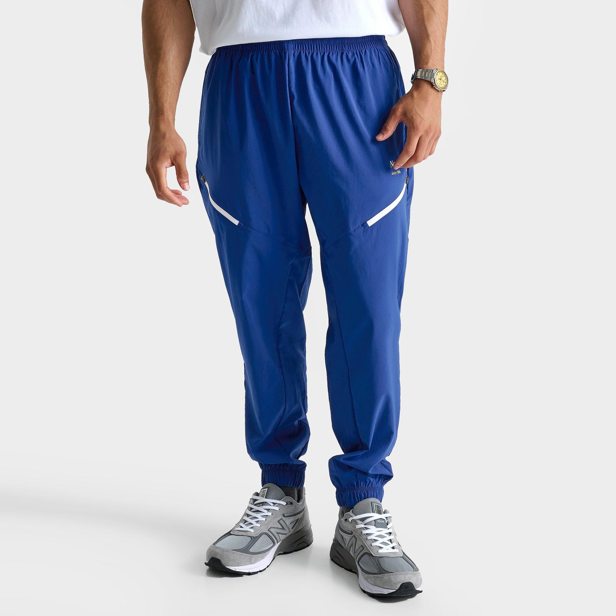 Click here for New Balance Mens Reimagined Woven Track Pants in N... prices